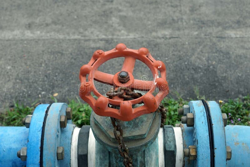 A Red Valve on the Pipe Plumbing beside a Street Stock Photo - Image of ...