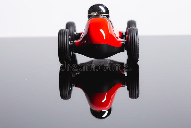 Red Vintage Car Backwards Reflected on a Black Surface Stock Photo ...