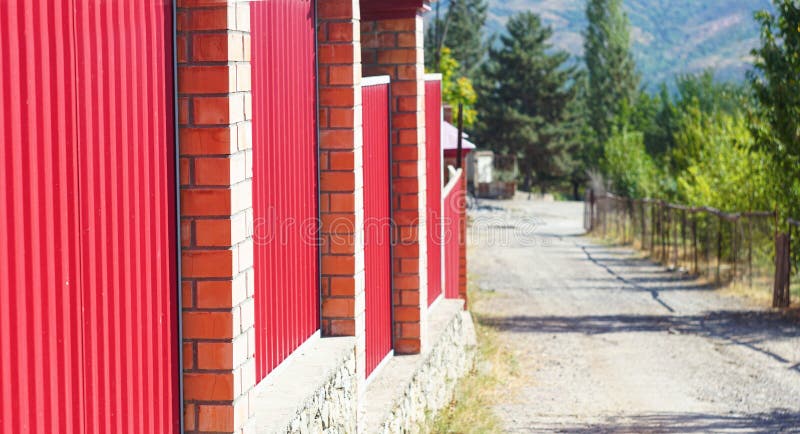 A Red Wall at the Edge of a Narrow Street Stock Image - Image of ...