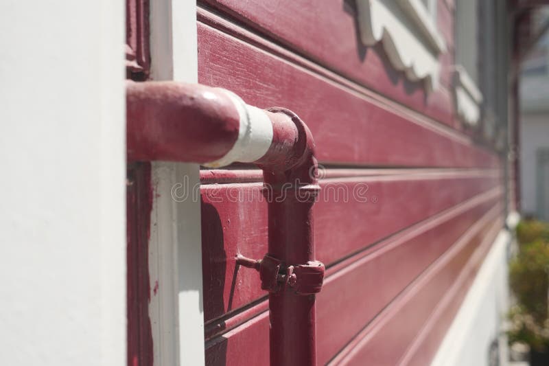 Red Wall with Pipe, Illuminated by Sun, Displaying Modern Urban Design ...