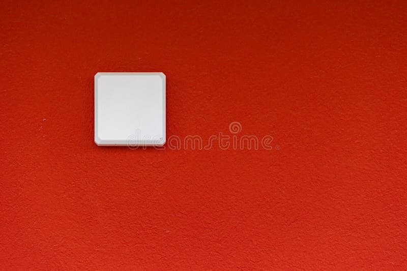 A Red Wall with a White Square Light Switch on it Stock Image - Image ...