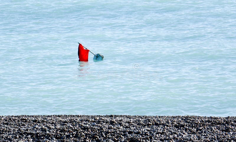 Red Warning Flag Floating on the Sea in a Windless Day Stock Image ...