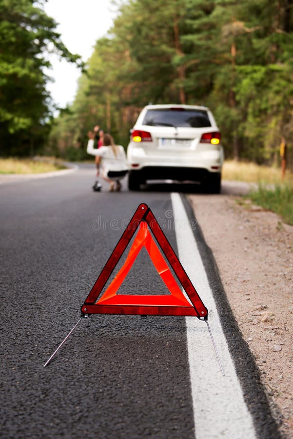 Red Warning Triangle and Broken Car in the Middle of Forrest Stock ...