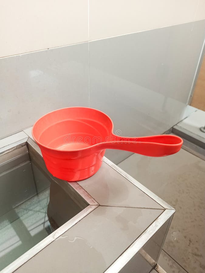 A Red Water Dipper is Placed in a Public Restroom in Thailand. Stock ...
