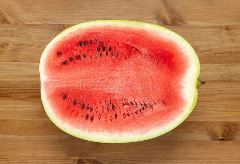 Red Watermelon Cut in Half, Top View, on Wooden Table Stock Image ...