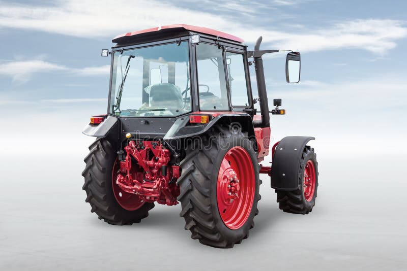 Red Wheeled Tractor Isolated on Bright Background with Sky Stock Photo ...