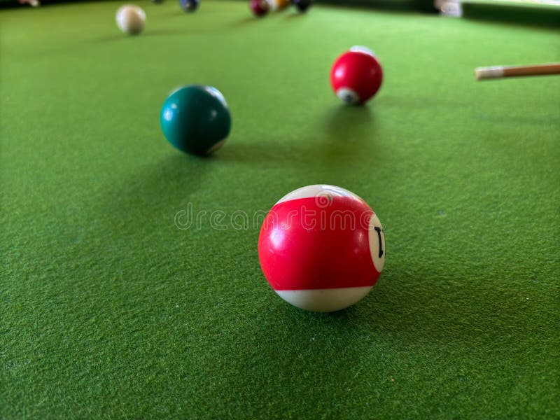 A Red and White Ball Sits on a Green Pool Table Stock Image - Image of ...