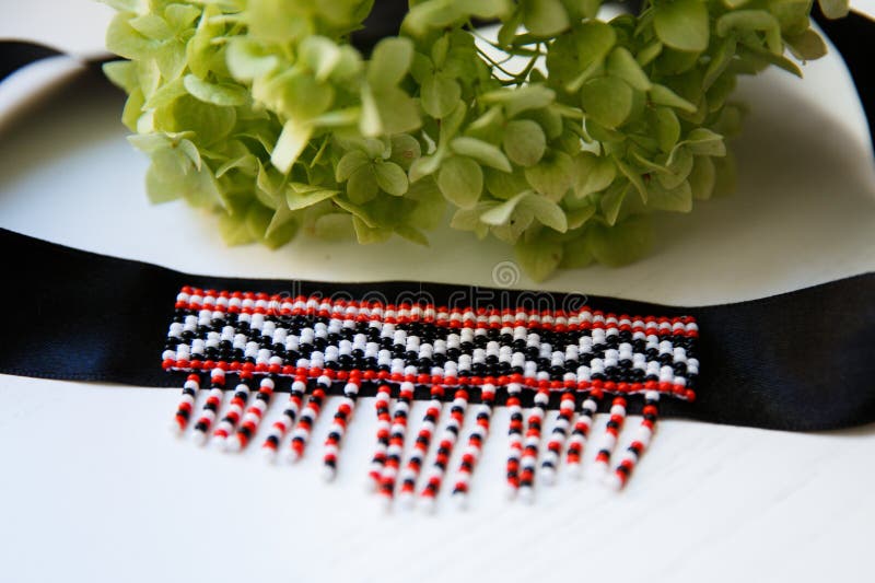 Red and White Beaded Bracelet on a Black Ribbon Stock Photo - Image of ...