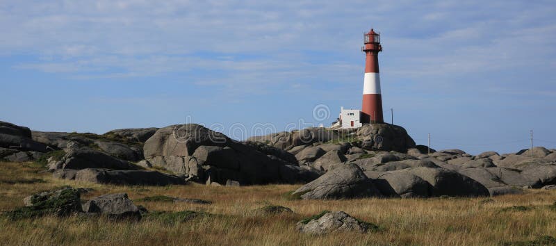 Red and White Cast Iron Eigeroy Lighthouse and Rock Formations Stock ...