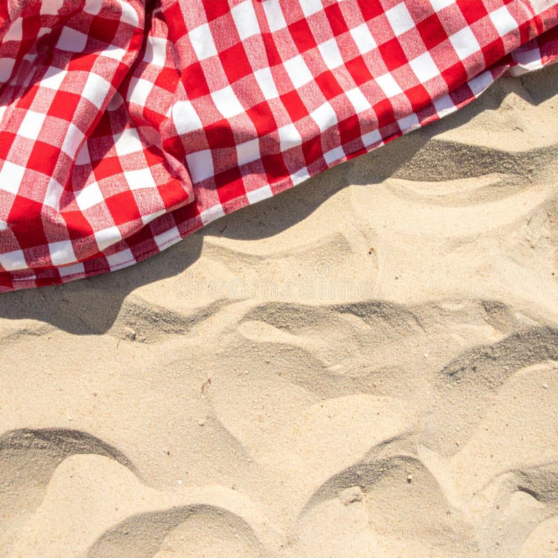 Red and White Checkered Cloth on Tan Sandy Beach Top View Layout Stock ...