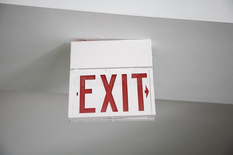 Red and White Exit Sign Hanging from the Ceiling Under the Lights Stock ...