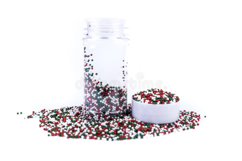 Red White and Green Sprinkles in a Container and Lid in a Pool of Tasty ...