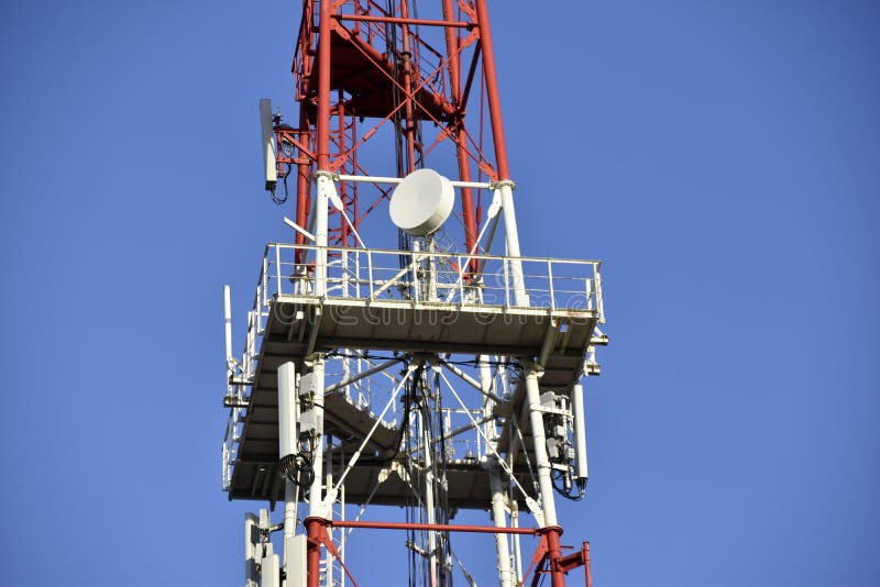 Red and White High Rise Communication Tower Antenna in the City with ...