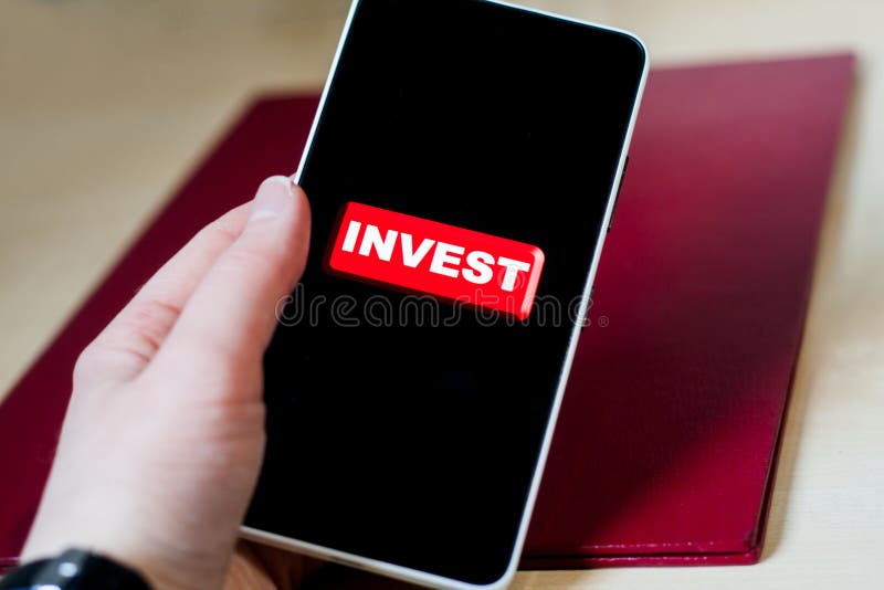 Invest Button on a Black Phone Screen Stock Image - Image of holding ...