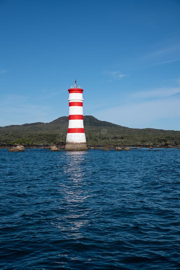 Red and White Lighthouse Near the Ocean Stock Photo - Image of vertical ...
