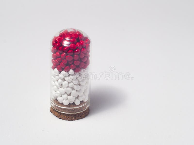 Red and White Masterbatch Granules Spilling from a Shot Glass Stock ...