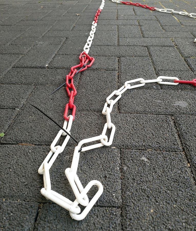 Red and White Members of a Chain on Grey Concrete Ground Stock Photo ...