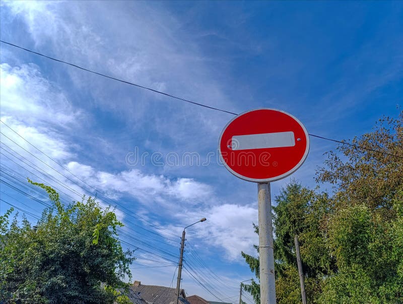 A Red and White No Entry Sign on a Pole in Front of a Blue Sky Stock ...