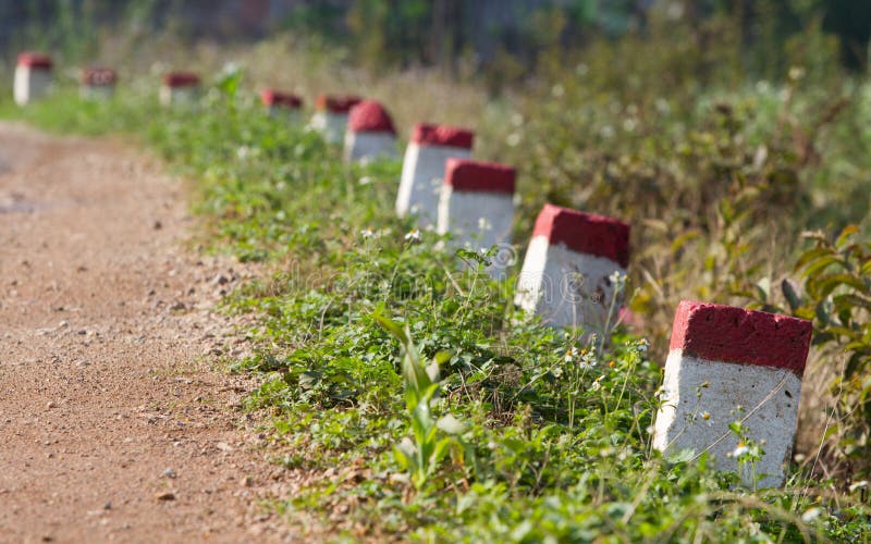 Red and White Painted Milestones Stock Image - Image of milestone, long ...