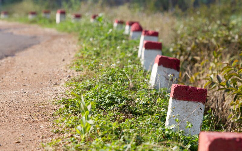 Red and White Painted Milestones Stock Photo - Image of geographical ...
