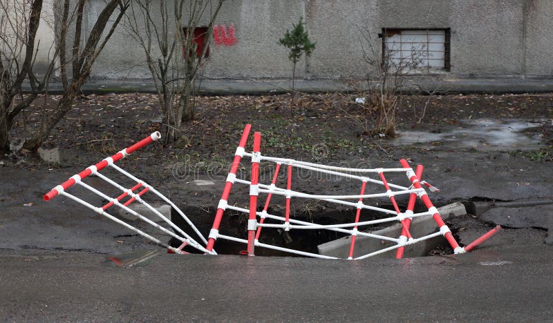 Red and White Plastic Barriers that Fell into the Pit at the Site of a ...