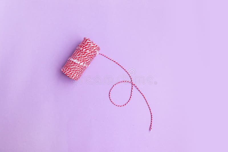 Red and White Rope Reel on a Solid Purple Background with Copy Space ...