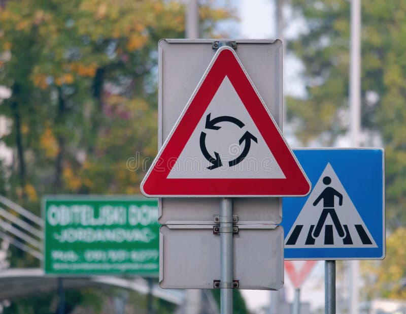 Red and White Roundabout Sign with a Pedestrian Crossing Sign in the ...