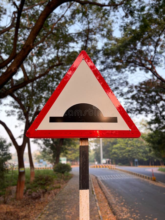 A Red and White Sign with a Black Triangle on it Stock Image - Image of ...