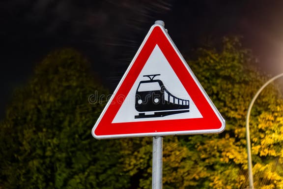 A Red and White Sign with a Train on it is on a Pole Stock Image ...