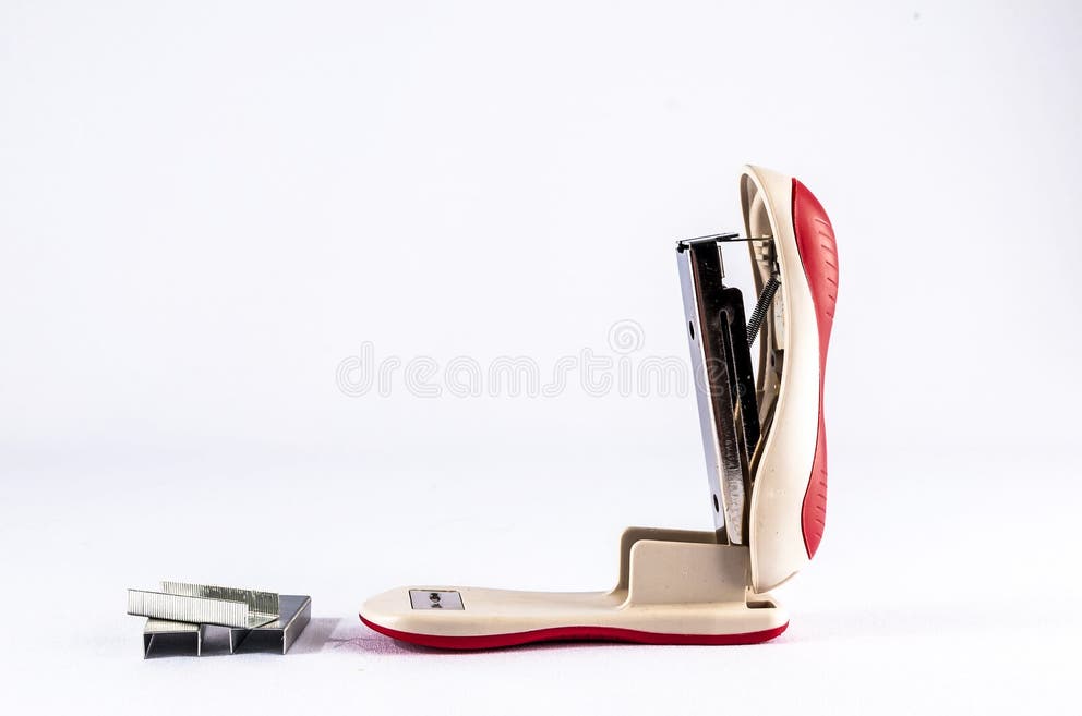 A Red and White Stapler with a Silver Base Stock Photo - Image of ...