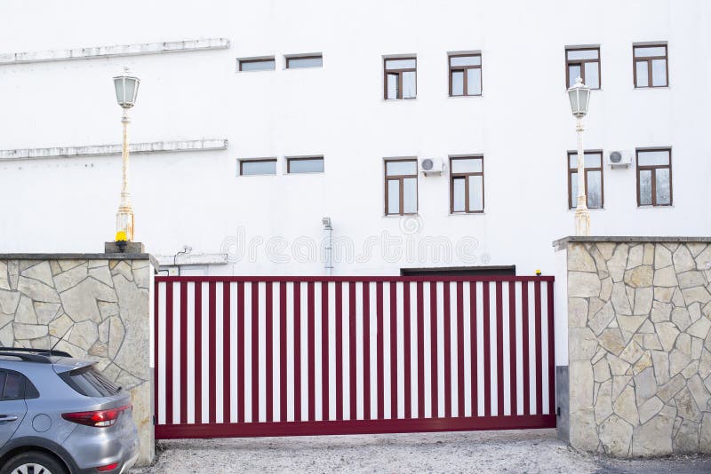 A Red-and-white Striped Gate on a Stone Wall Stock Photo - Image of ...