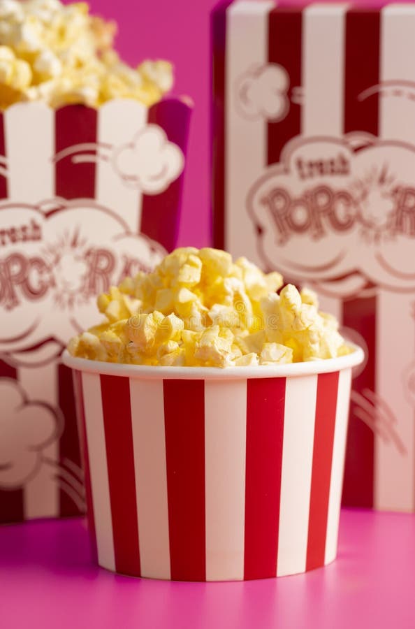 Red and White Striped Popcorn Bucket on a Bright Pink Background Stock ...
