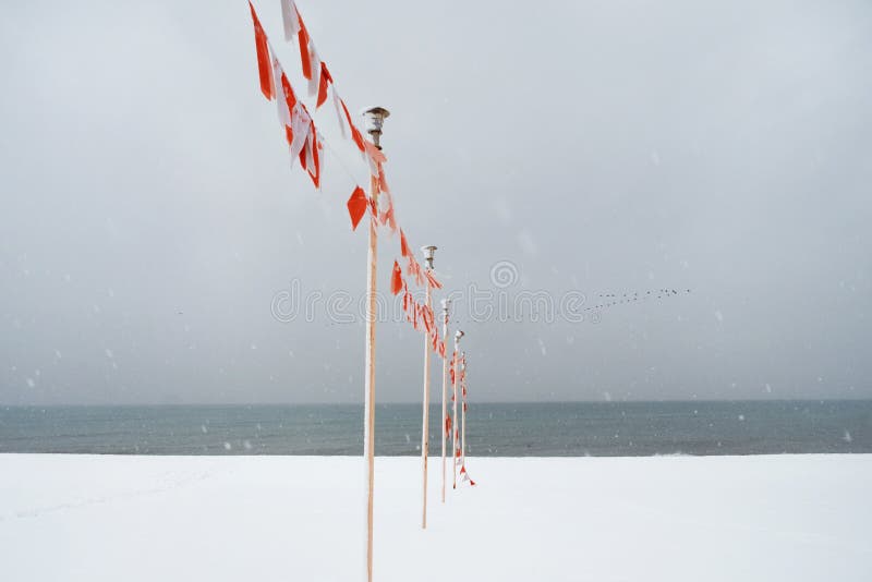Red and White Triangle Flags the Beach Covered with Snow Stock Image ...