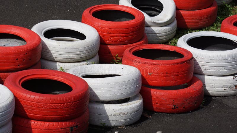 Red and White Used Tires on the Asphalt at the Side of the Road Stock ...