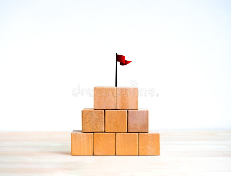 Red Win Flag on Top of 5 Wood Blocks Pyramid Stack Isolated on Wooden ...