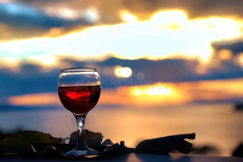 Red Wine in a Glass on the Blurred Background of the Sky, Clouds and ...