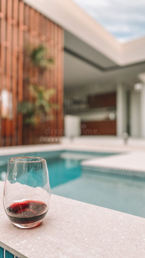 Red wine poolside stock image. Image of glass, poolside - 200863661