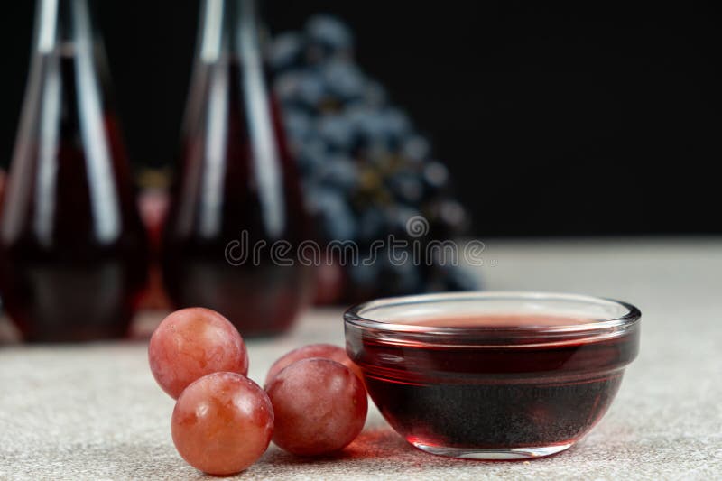 Red Wine Vinegar in Glass Vinegar Bowls among Grapes Stock Photo ...