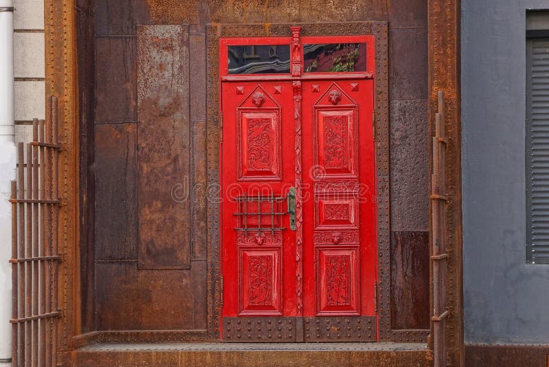 Red Wooden Door on a Rusty Brown Building Wall Stock Photo - Image of ...