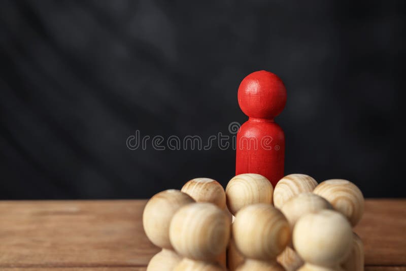 Red Wooden Figures Stand Out from the Crowd of Wooden Figures Stock ...