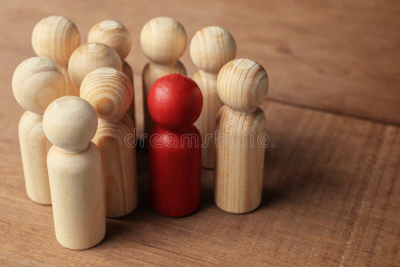 Red Wooden Figures Stand Out from the Crowd of Wooden Figures Stock ...
