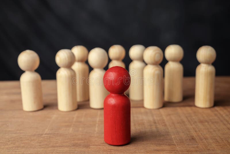 Red Wooden Figures Stand Out from the Crowd of Wooden Figures Stock ...