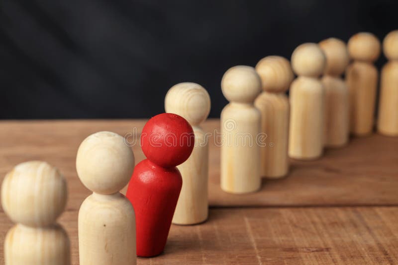 Red Wooden Figures Stand Out from the Crowd of Wooden Figures Stock ...