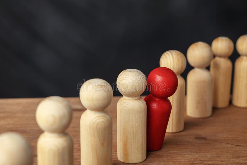 Red Wooden Figures Stand Out from the Crowd of Wooden Figures Stock ...