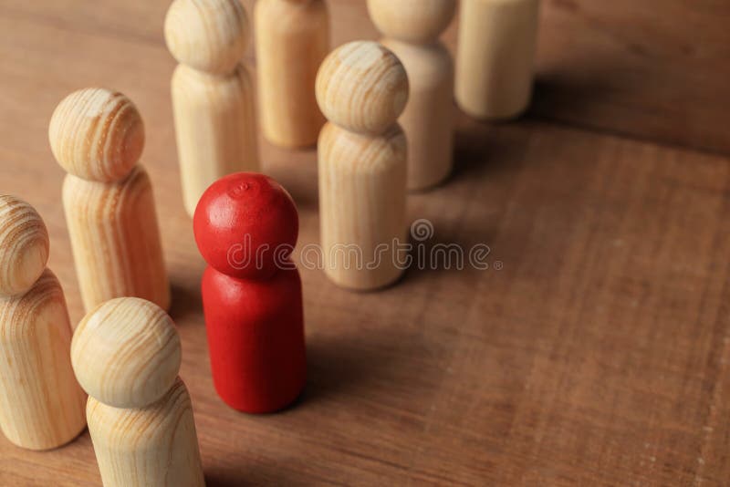 Red Wooden Figures Stand Out from the Crowd of Wooden Figures Stock ...