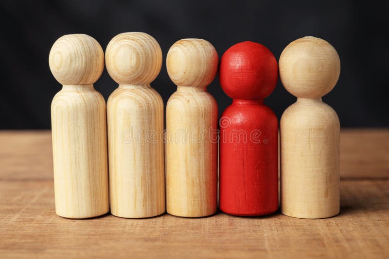 Red Wooden Figures Stand Out from the Crowd of Wooden Figures Stock ...