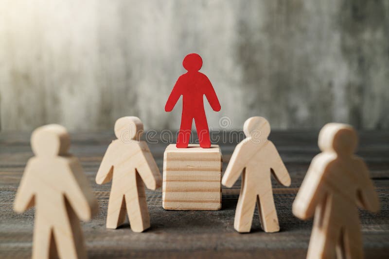 Red Wooden Figures Stand Out from the Crowd of Wooden Figures Stock ...