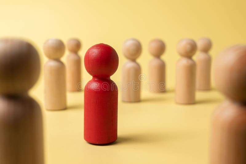 Red Wooden Figures Stand Out from the Crowd of Wooden Figures Stock ...