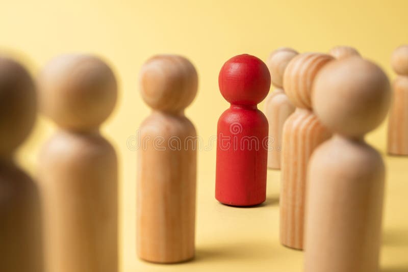Red Wooden Figures Stand Out from the Crowd of Wooden Figures Stock ...