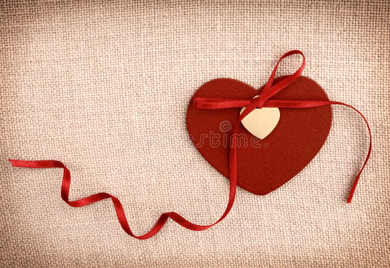 A Red Wooden Heart with a Ribon Bow on Vintage Fabric Backgroun Stock ...